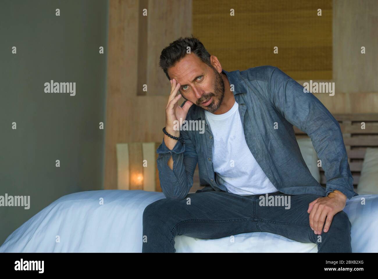 lifestyle home portrait of young attractive stressed and depressed man ...