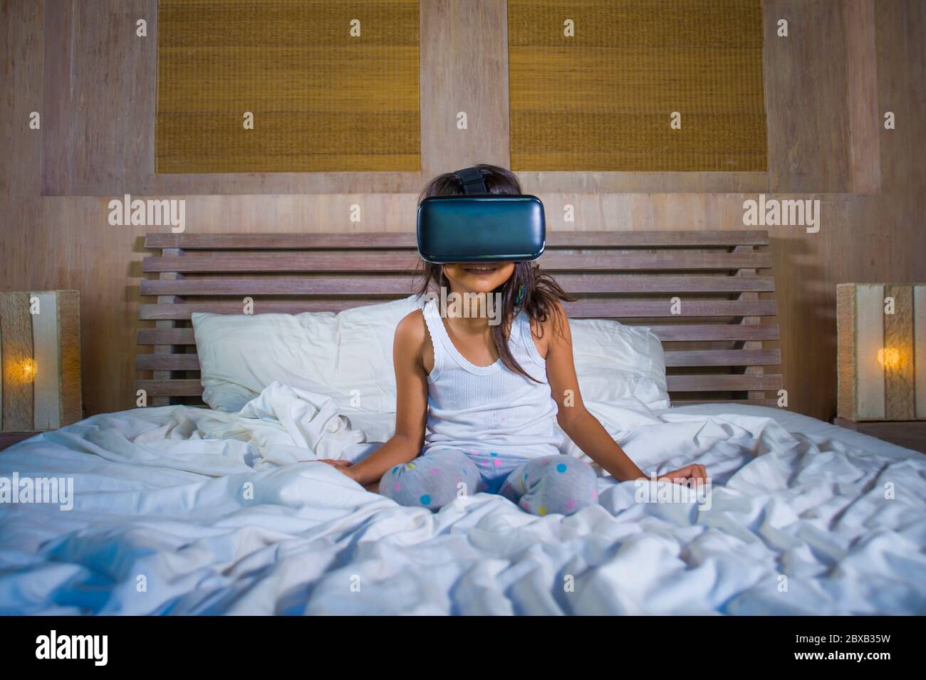 lifestyle portrait of young happy and excited female child wearing VR ...