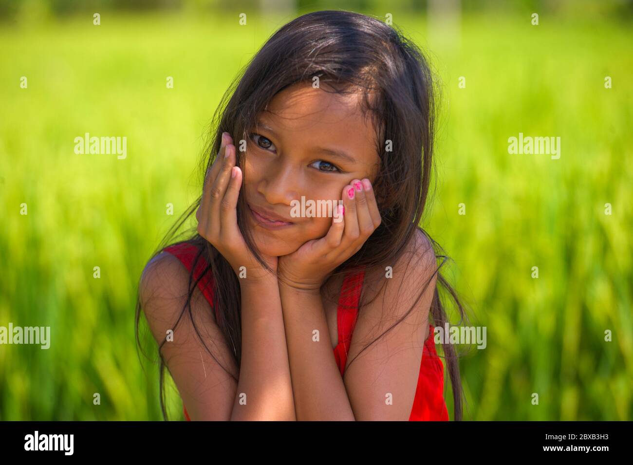 sweet happy and beautiful 7 or 8 years old child in cute red dress ...
