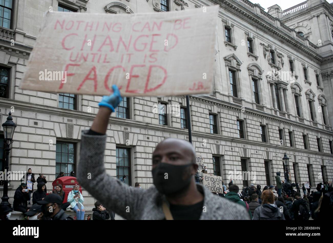 A protester walks past institutional buildings in central London ...
