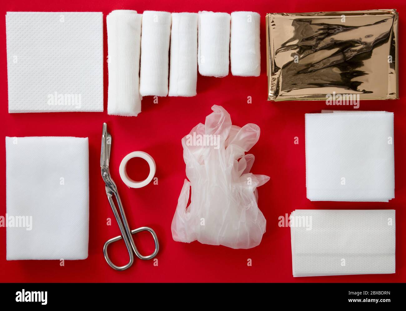 Insides of a first aid kit isolated on a red background Stock Photo - Alamy