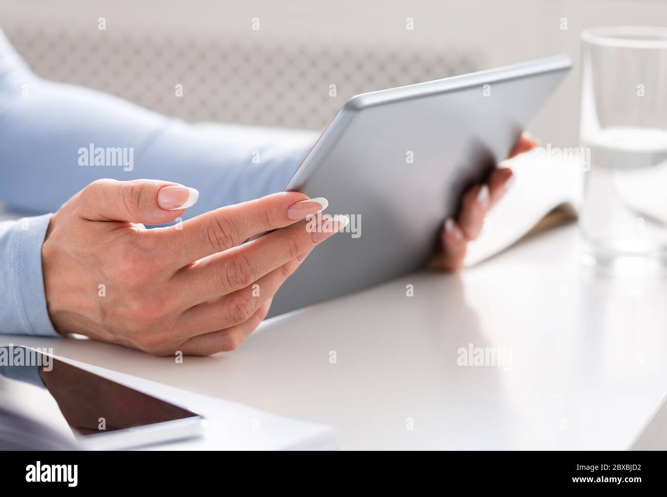 Remote work with digital devices. Woman hands holds tablet Stock Photo ...