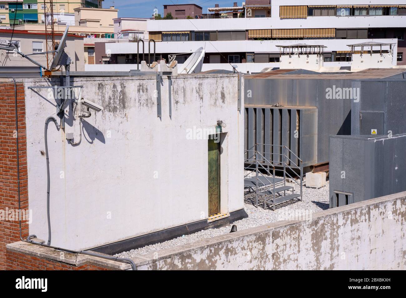Emergency exit on a rooftop of a building net to antennas, satellite ...