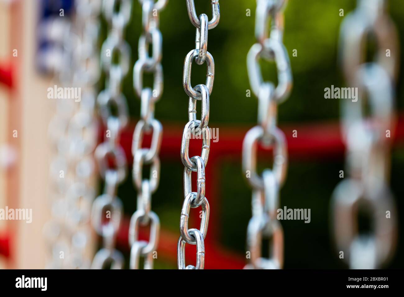 metal chains on a background of greenery, close-up Stock Photo - Alamy
