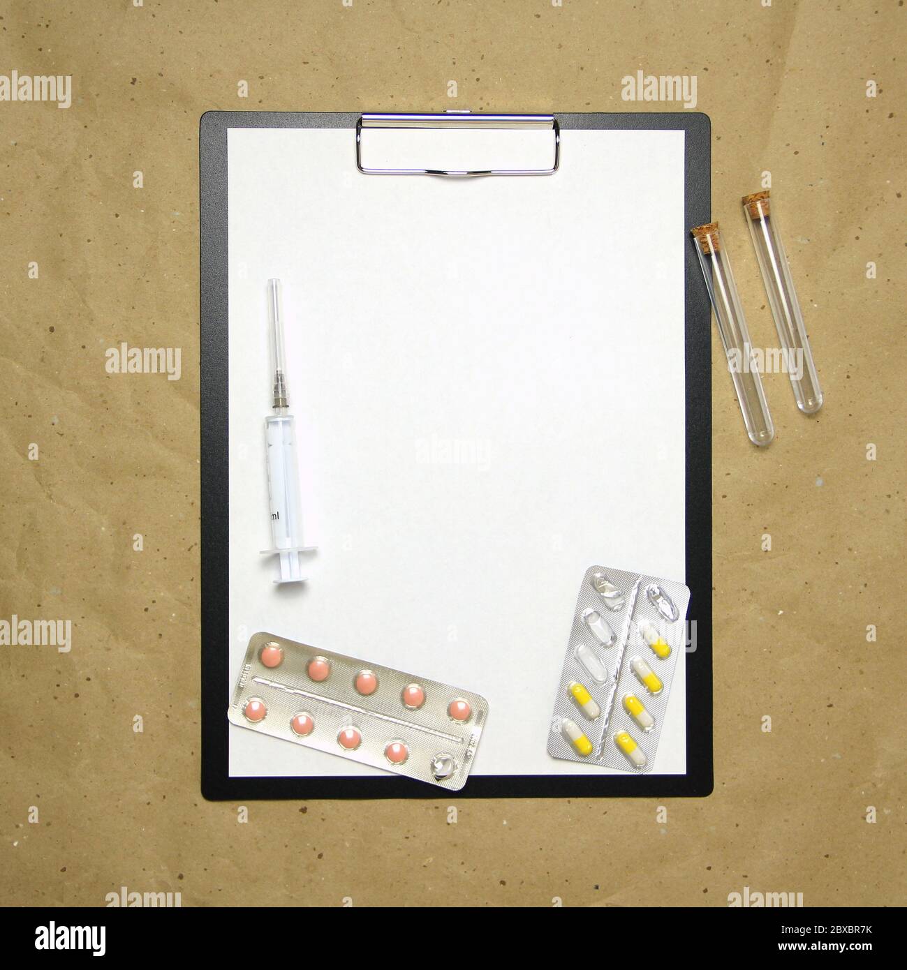 The tablet with a clip for the clip of paper with a white sheet a4 lies ...