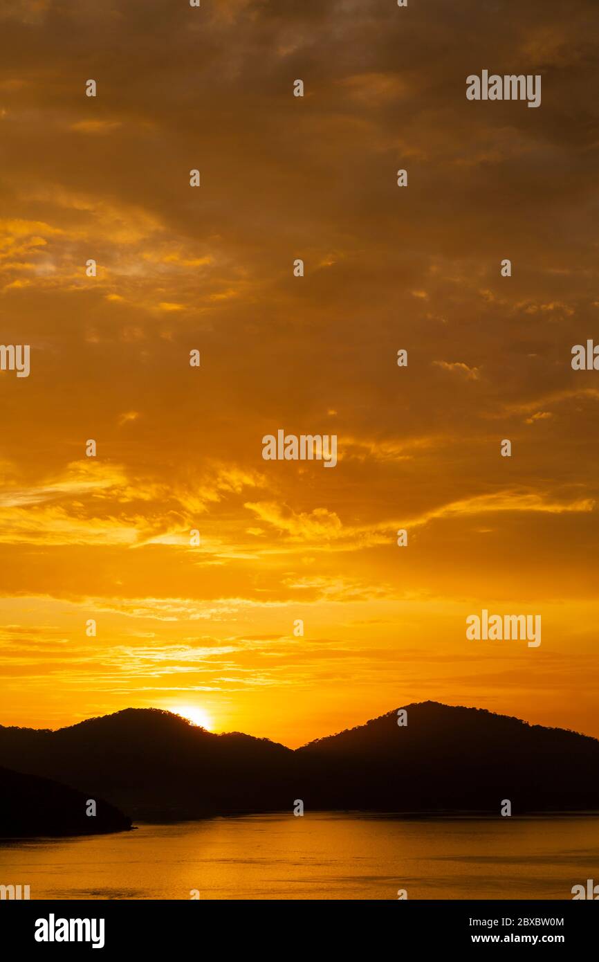 Orange sunset in the tropical beach town of Batu Ferringhi, Penang ...