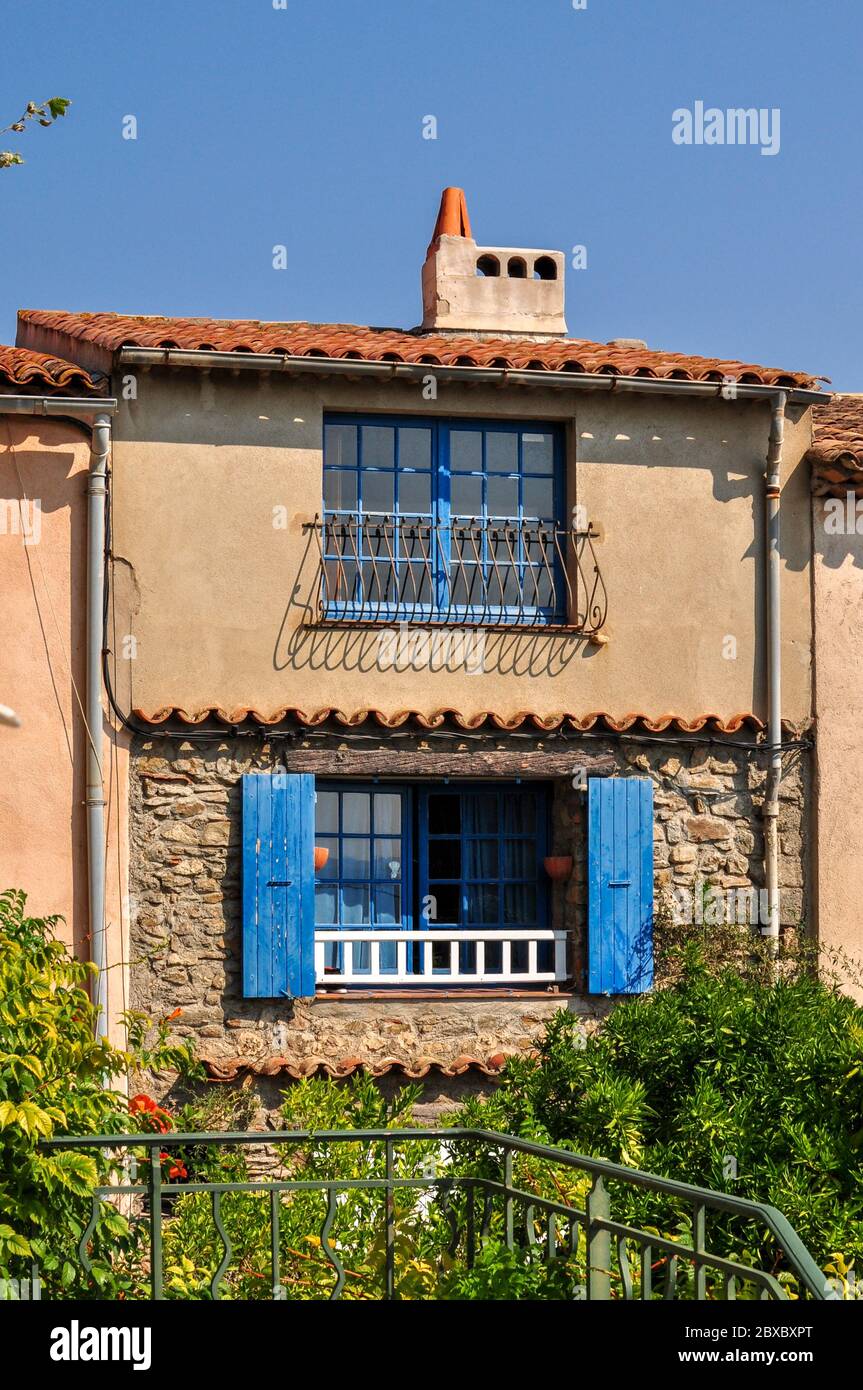 A house with blue windows and shutters in Provence, France Stock Photo ...