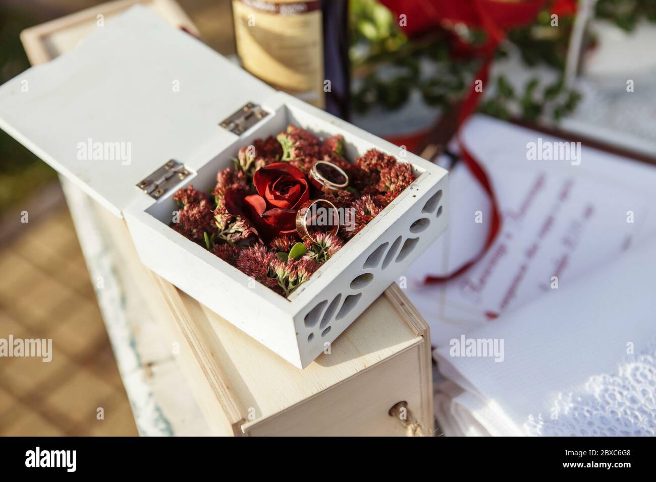 Two gold wedding rings in a beautiful wooden casket with green moss ...