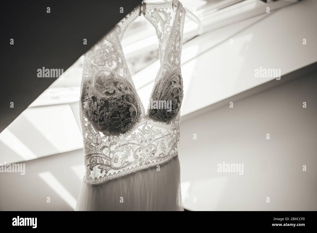 Close up of upper part of wedding gown. Lace dress in back-light. White ...