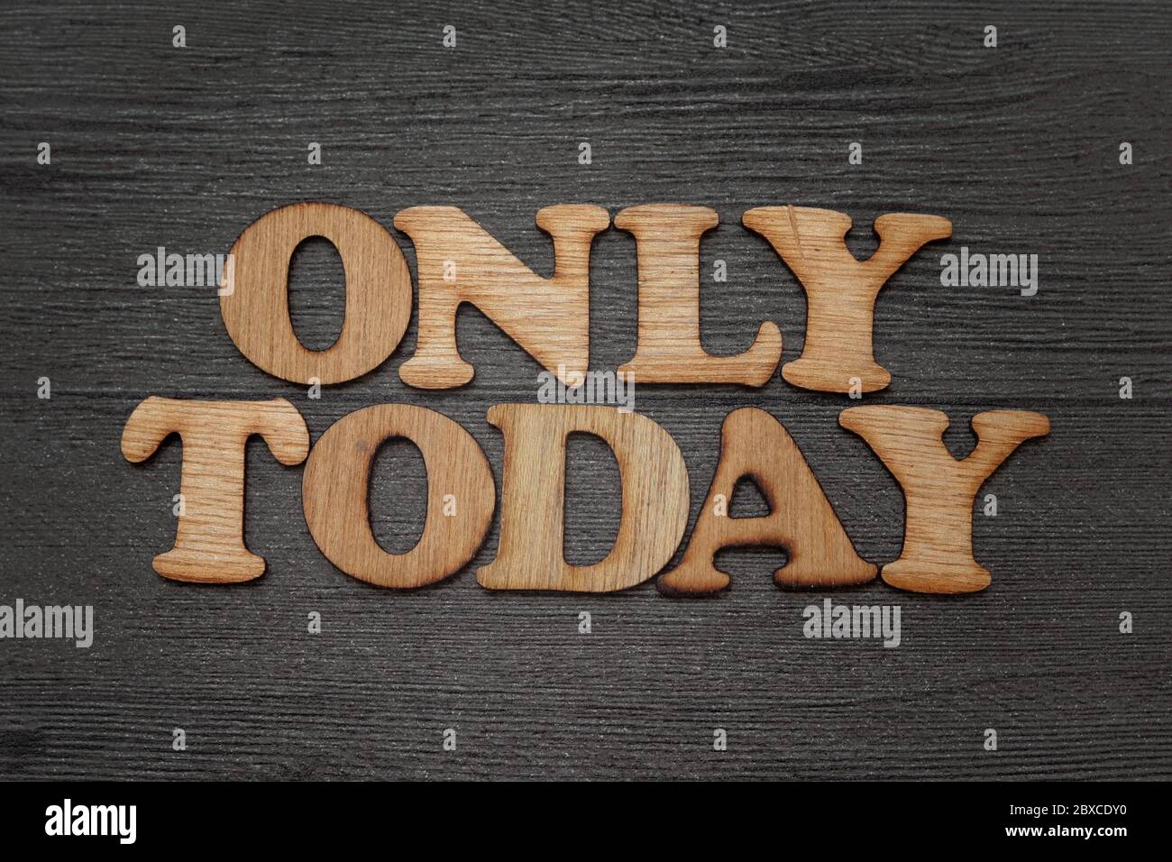 Only today word text, wooden alphabet lettering on dark background with ...