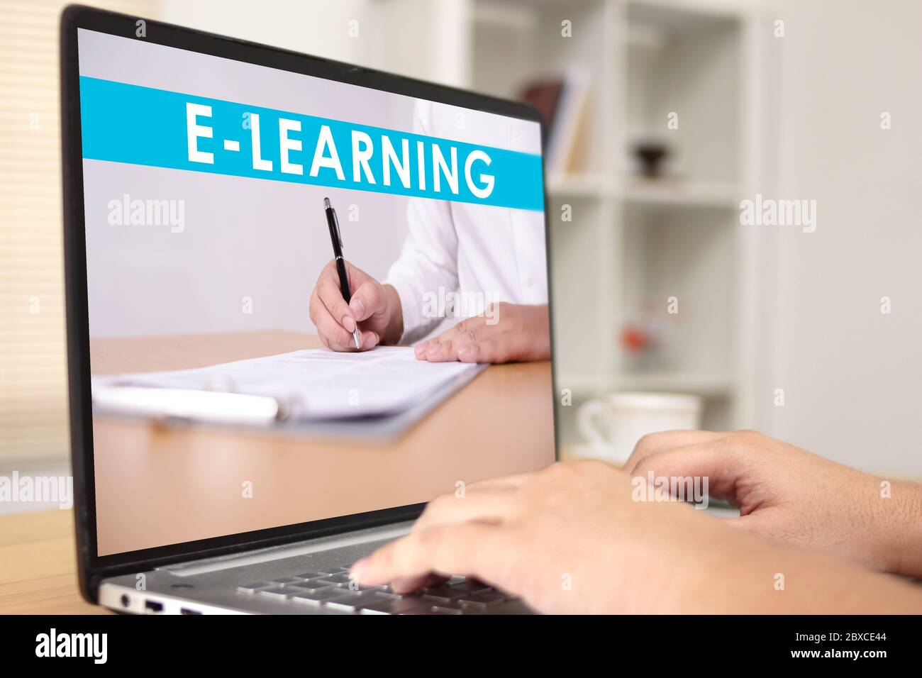 Anonymous person typing on laptop with e learning digital web program ...