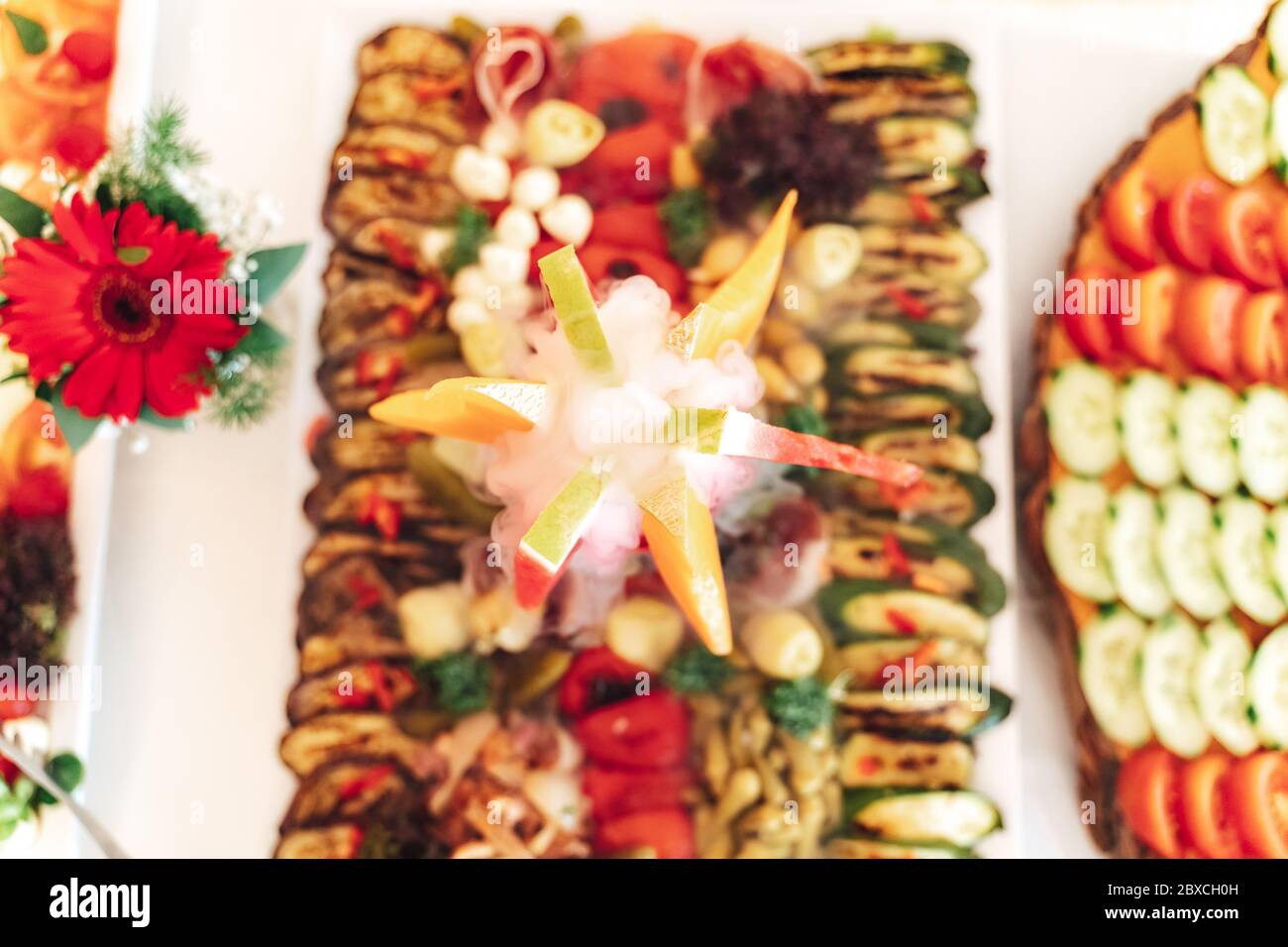 Top view of smoking glass at fruit and vegetable buffet table. Chemical ...