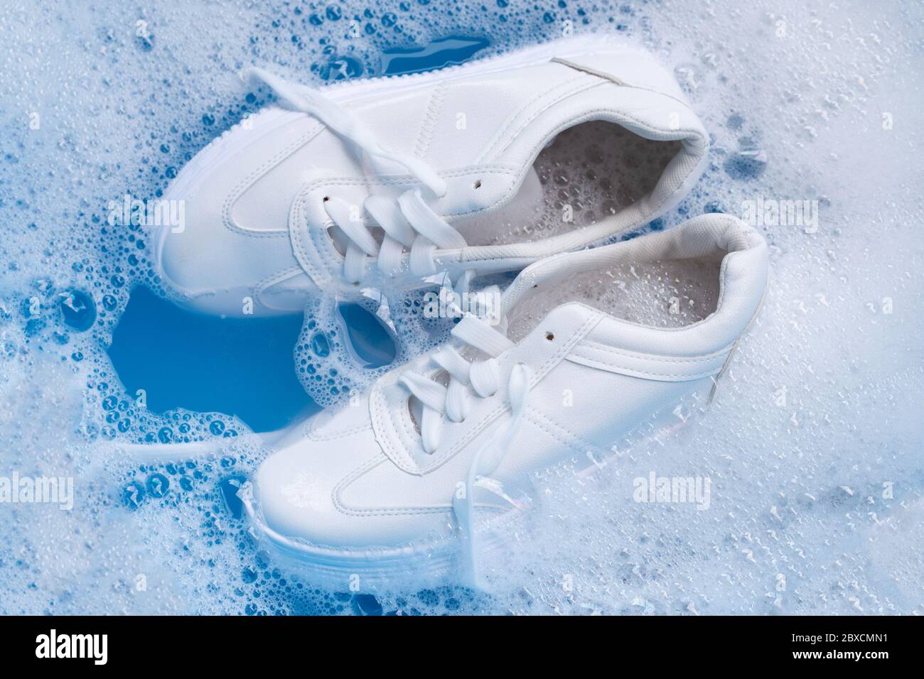 Soak shoes before washing. Cleaning Dirty sneakers Stock Photo - Alamy