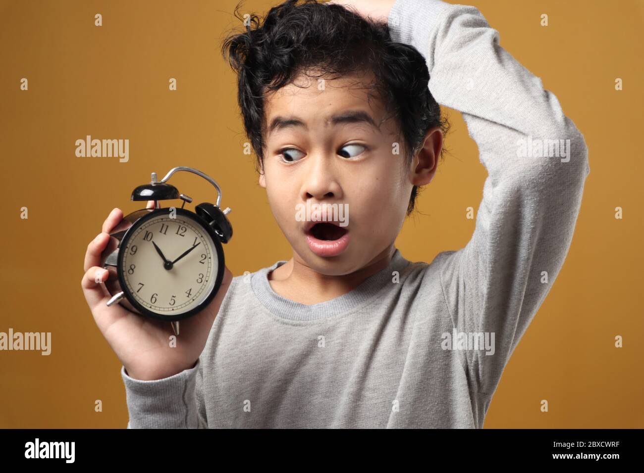 Funny Asian boy awake and shocked because it is too late, young student ...