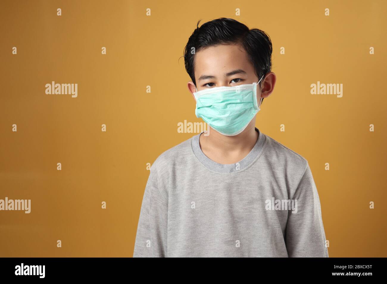 Young boy wearing mask during coronavirus covid-19 pandemic, standing ...