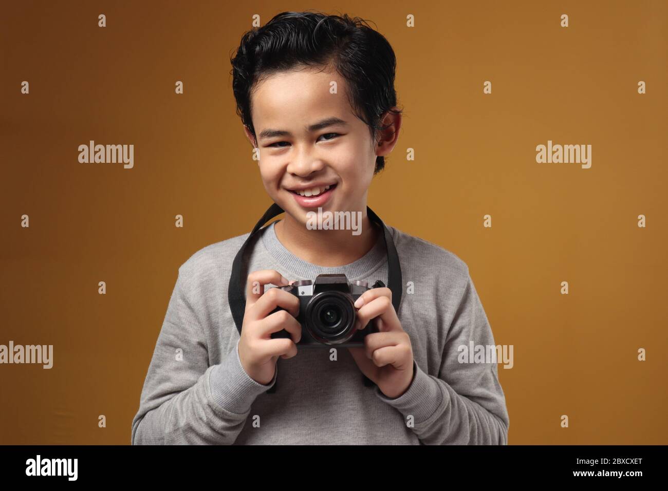 Happy Asian boy doing photography leisure activity, kid as photographer ...