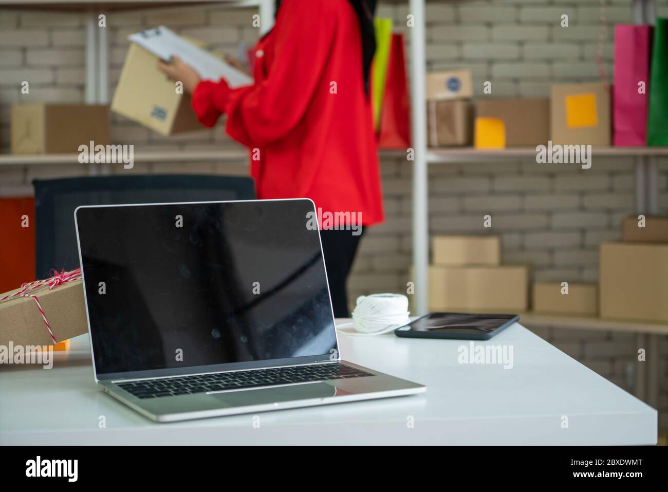 Laptop computer with empty screen on shipping box background. Concept ...