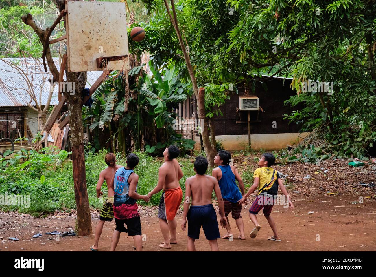 Local residents play basketball on an unequipped Playground Stock Photo ...