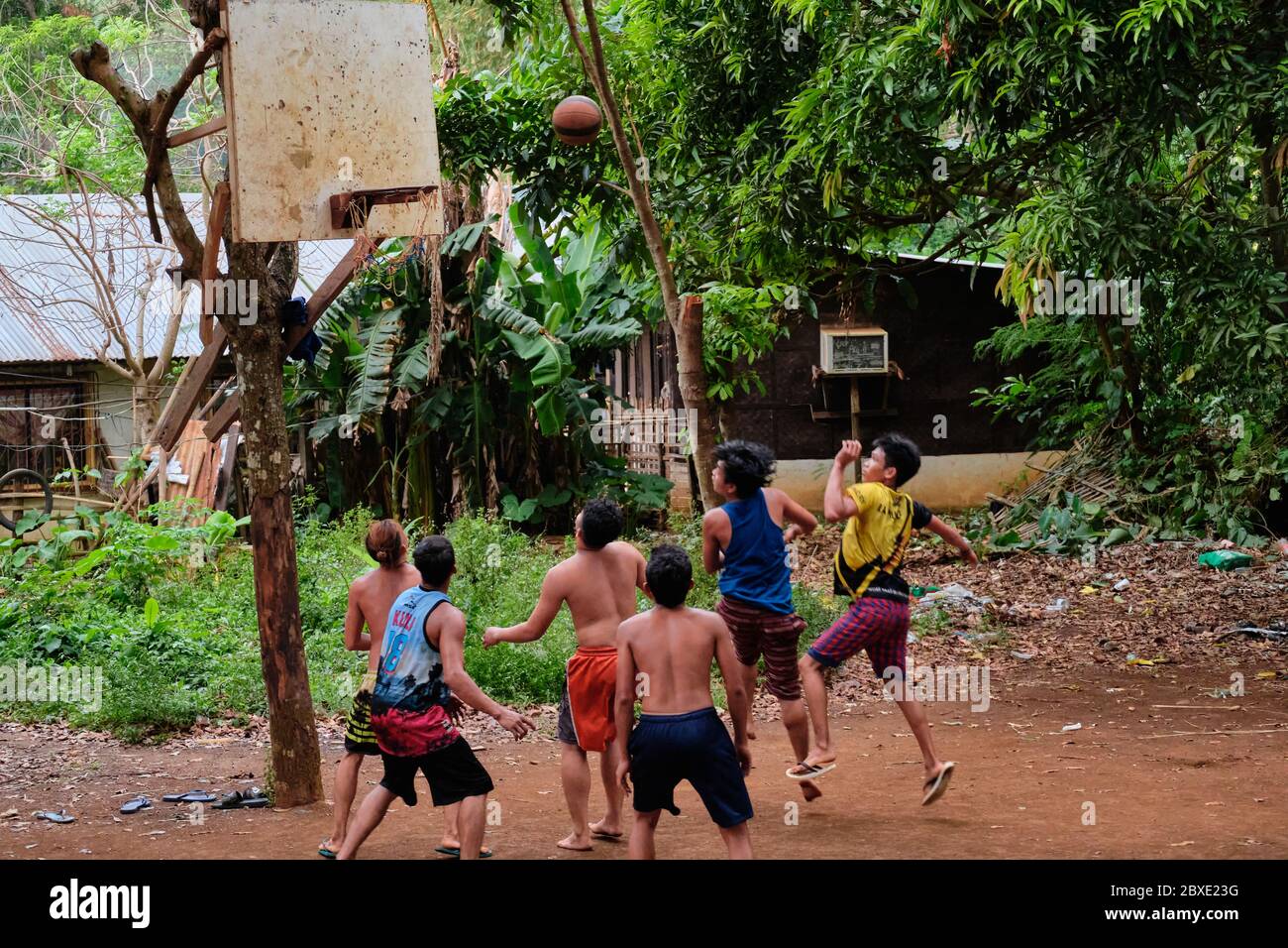 Local residents play basketball on an unequipped Playground Stock Photo ...