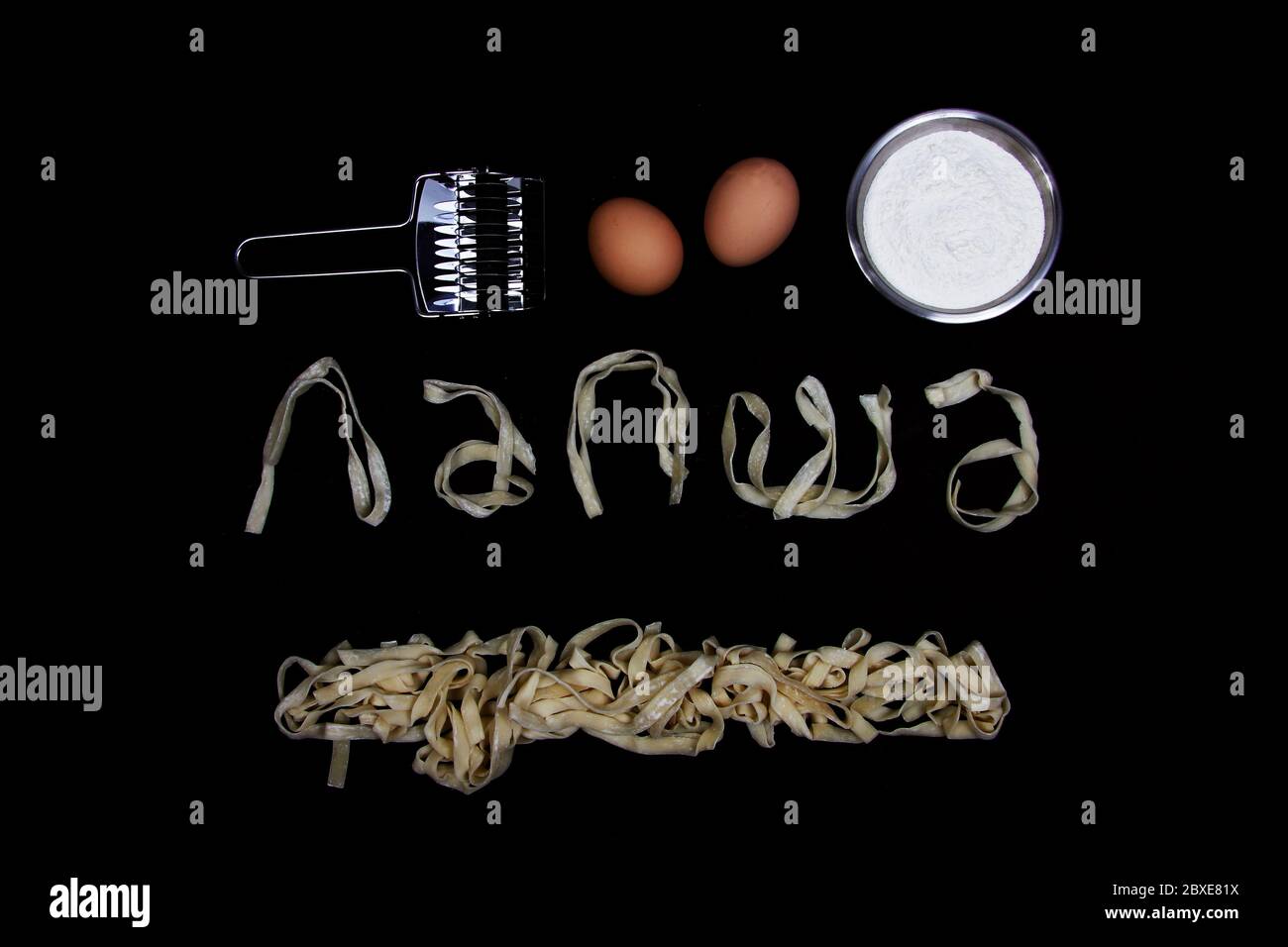 lettering LAPSHA (noodles in russian), made of noodles, eggs, bowl of ...