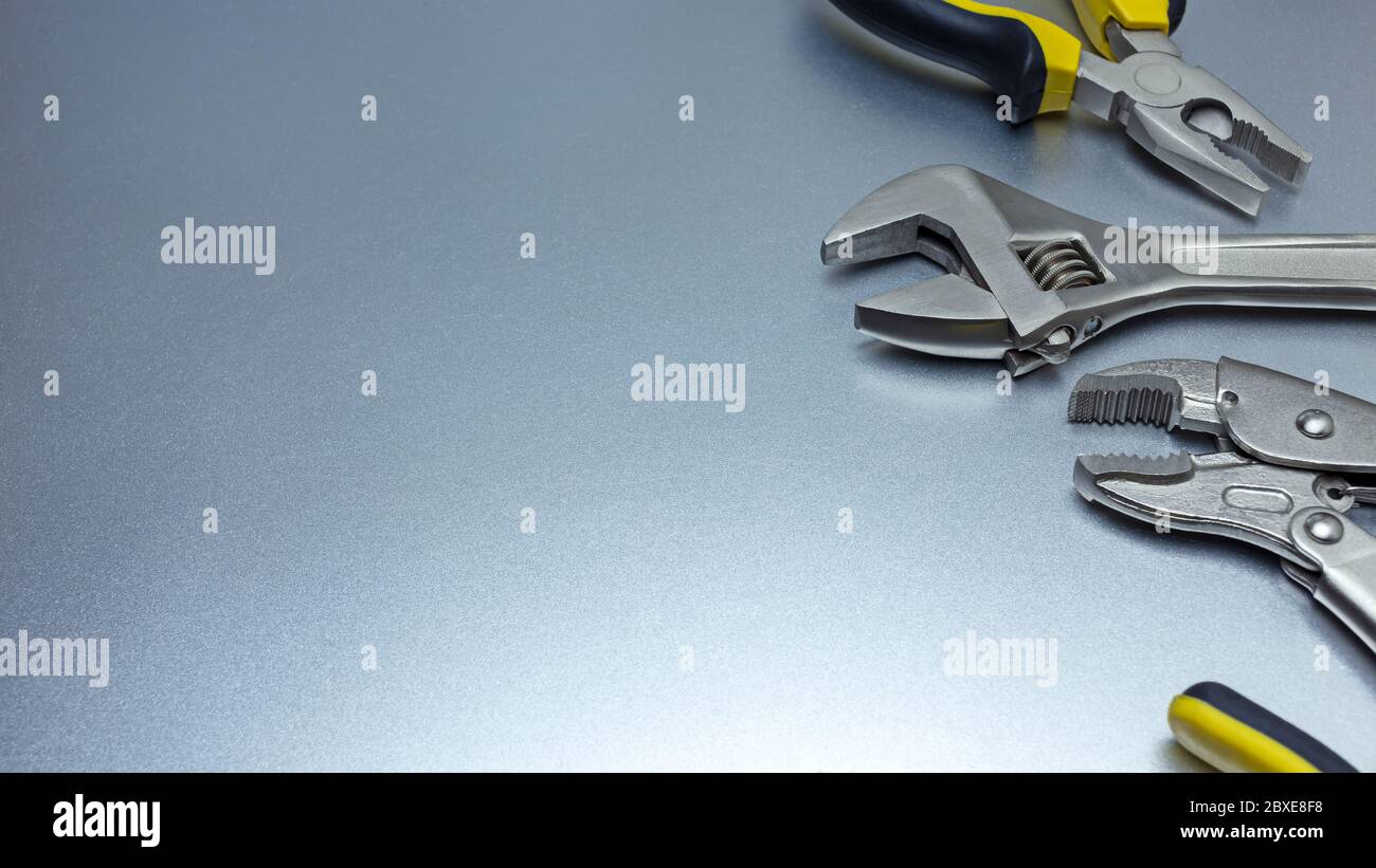 different fixing tools on grey metallic background. construction, house ...