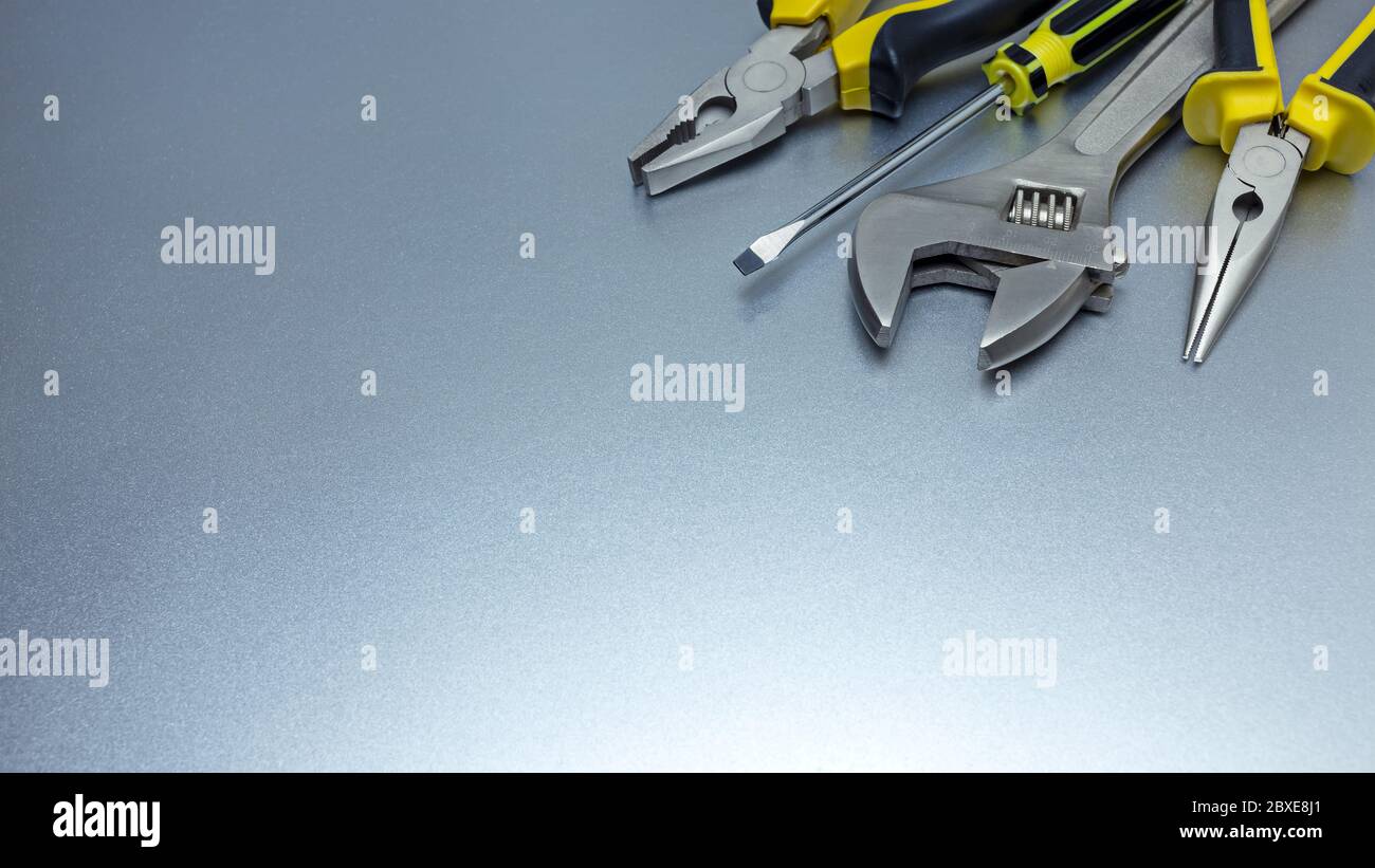 grey metal background with different working hand tools. construction ...