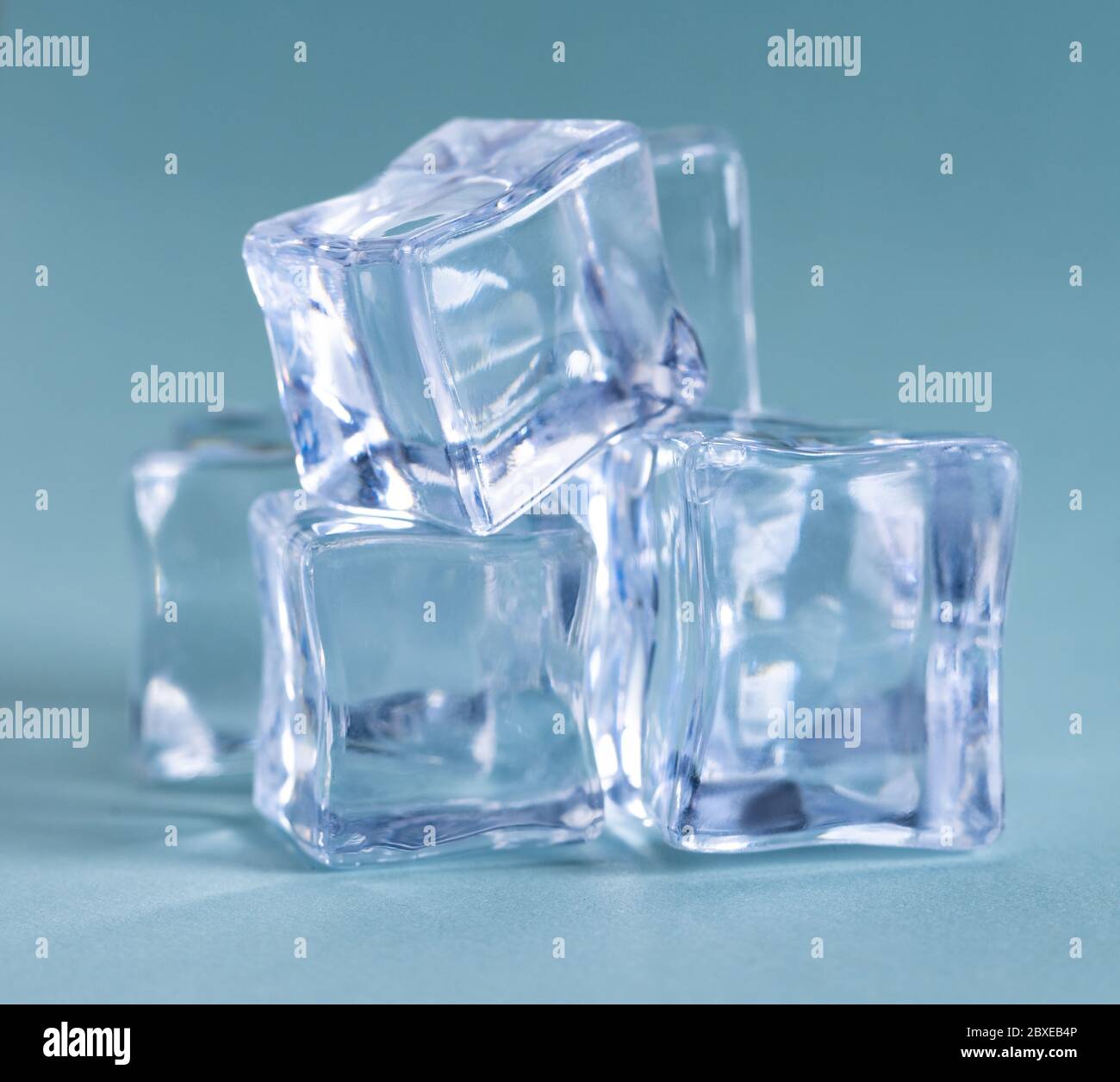 Pile of plastic ice cubes isolated on blue background Stock Photo - Alamy