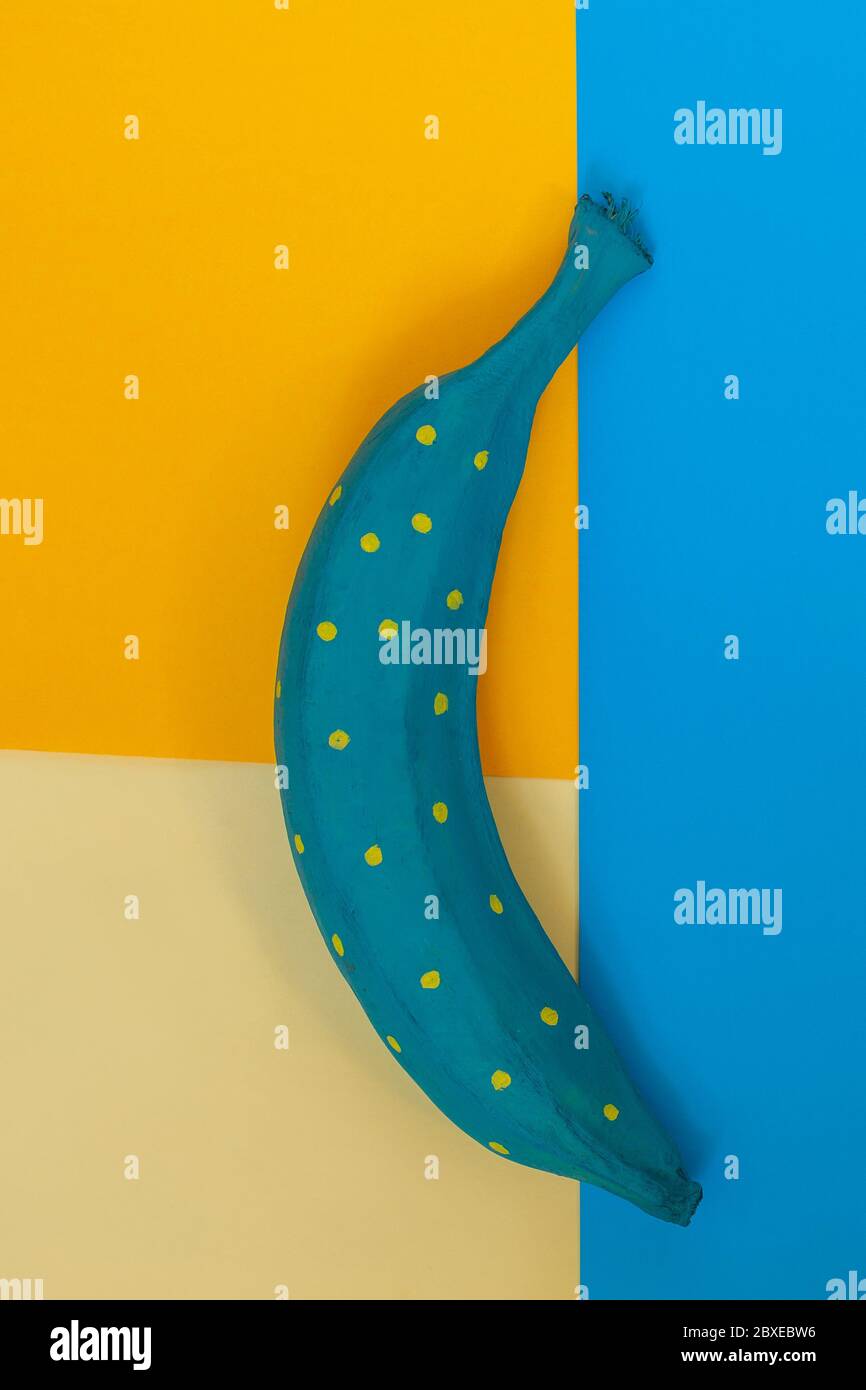 colored bananas on orange, blue cardboard Stock Photo - Alamy