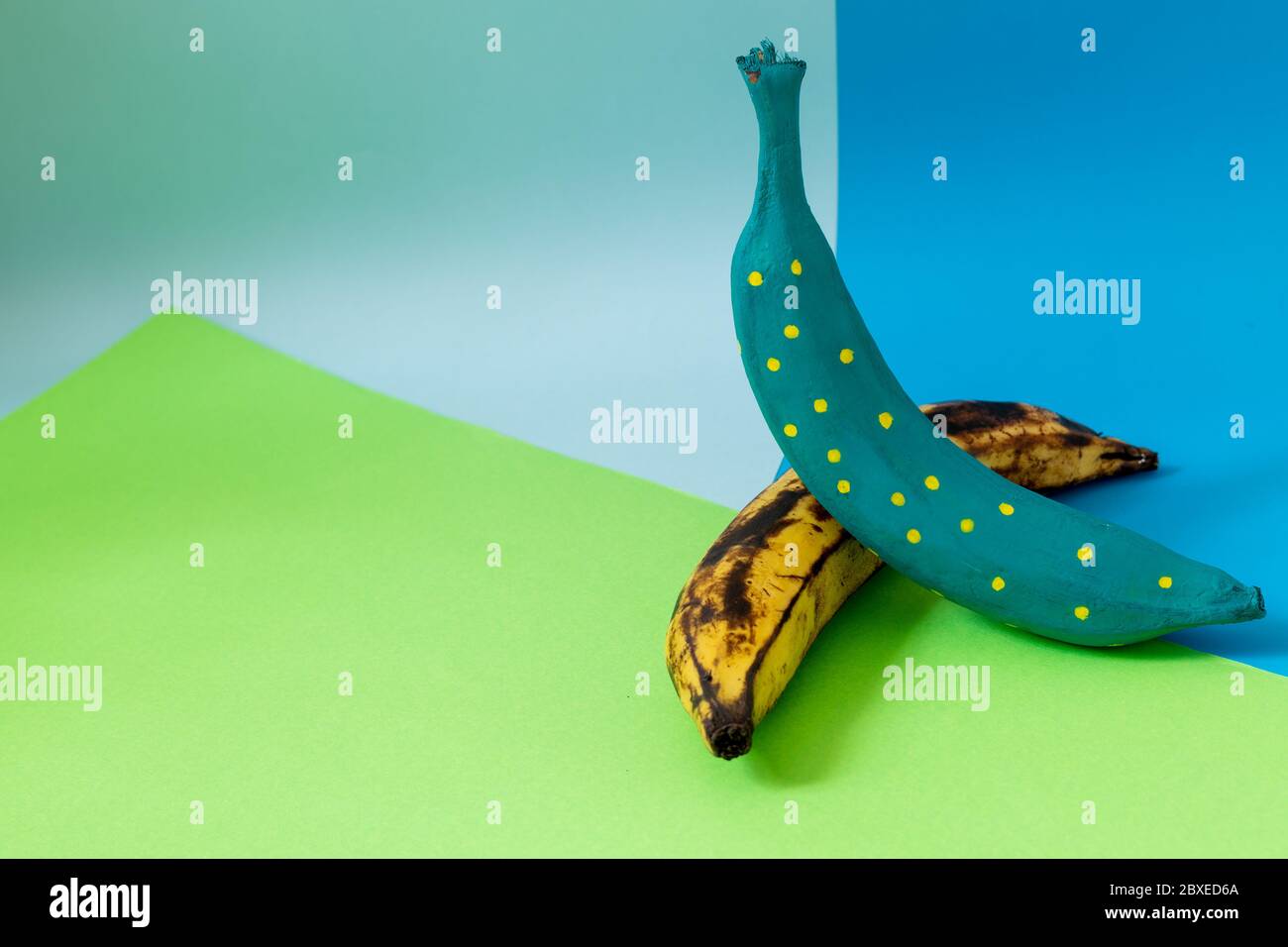 colored bananas on orange, blue cardboard Stock Photo - Alamy