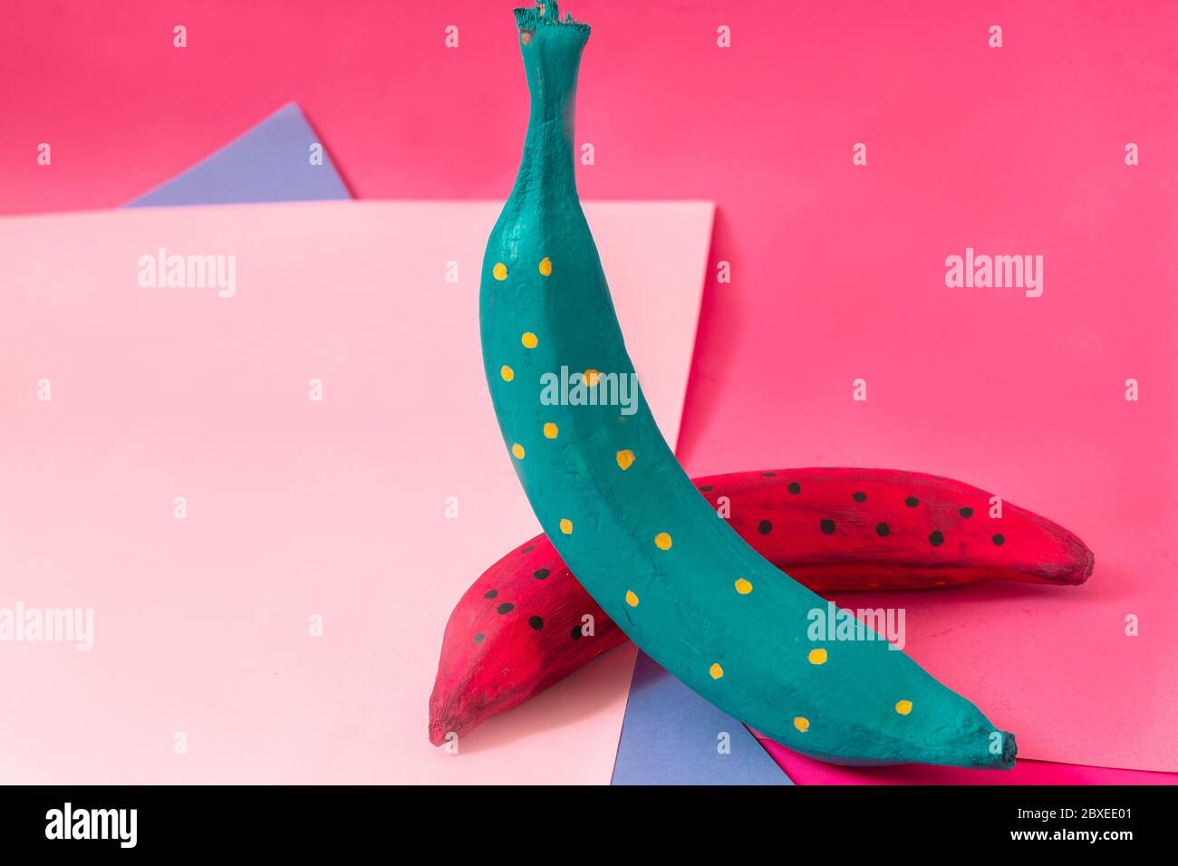 colored bananas on orange, blue cardboard Stock Photo - Alamy