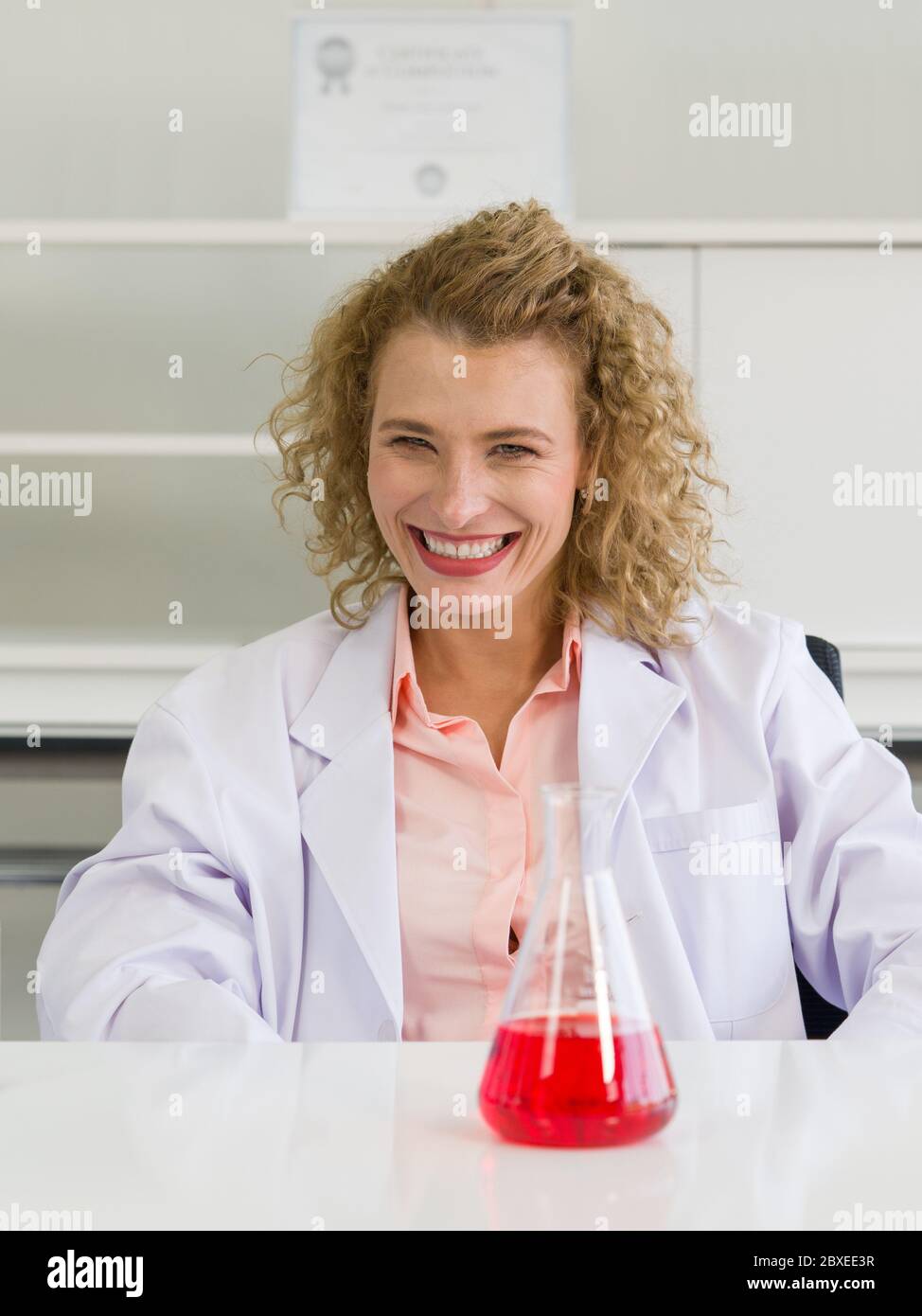 Young blonde scientist showed a happy face with the results of the ...