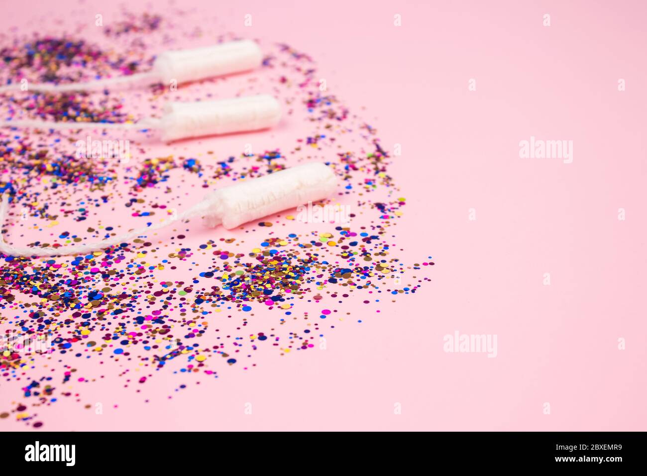 Set of clean cotton tampons with colorful sparkles on pink background ...
