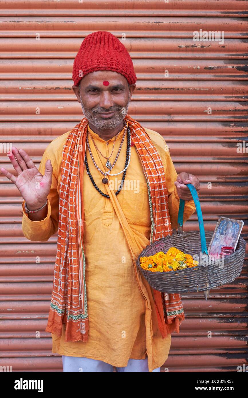 A Hindu priest in Kathmandu, Nepal, going from shop to shop or house to ...
