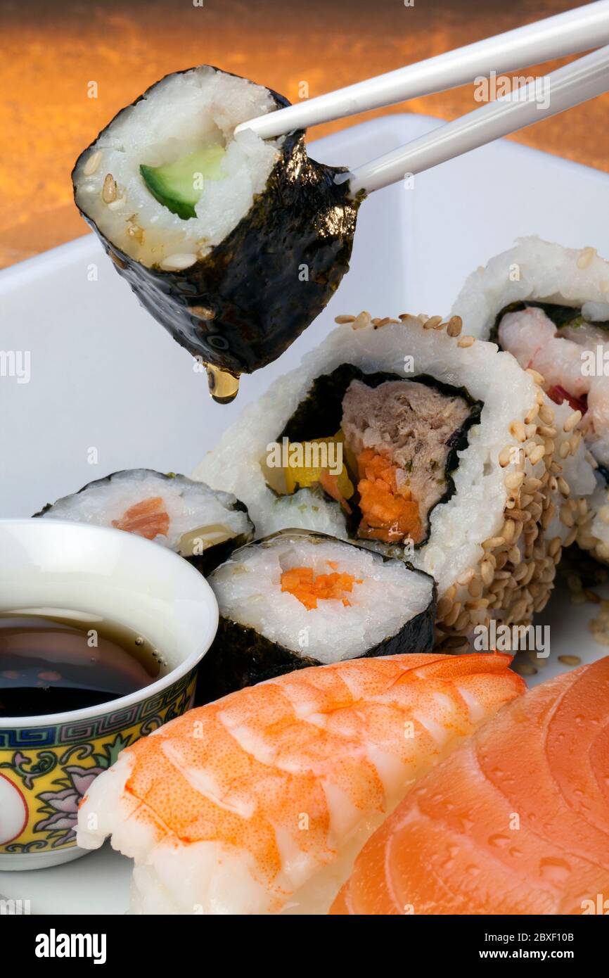 Sushi is a Japanese dish consisting of small balls or rolls of vinegar ...