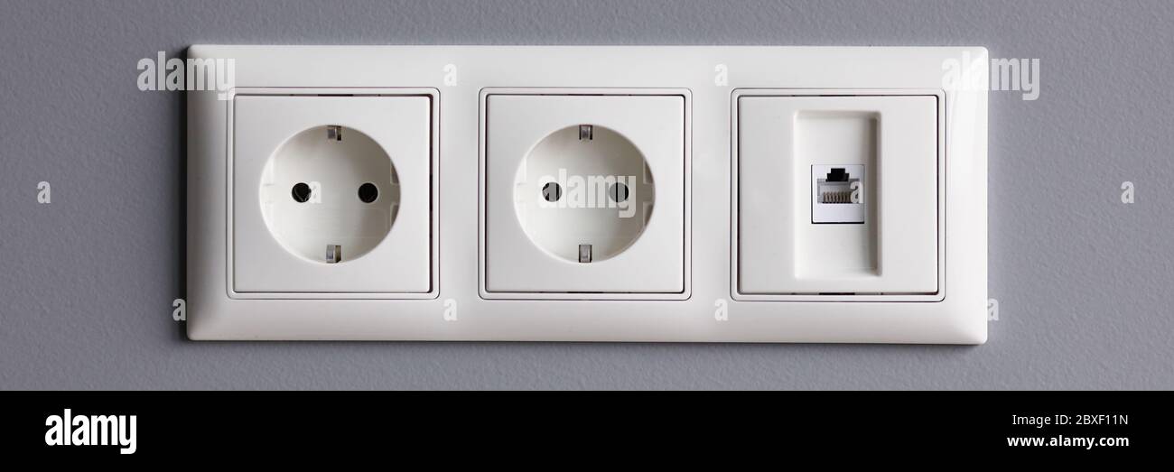 Modern white house outlet on gray wall closeup Stock Photo - Alamy