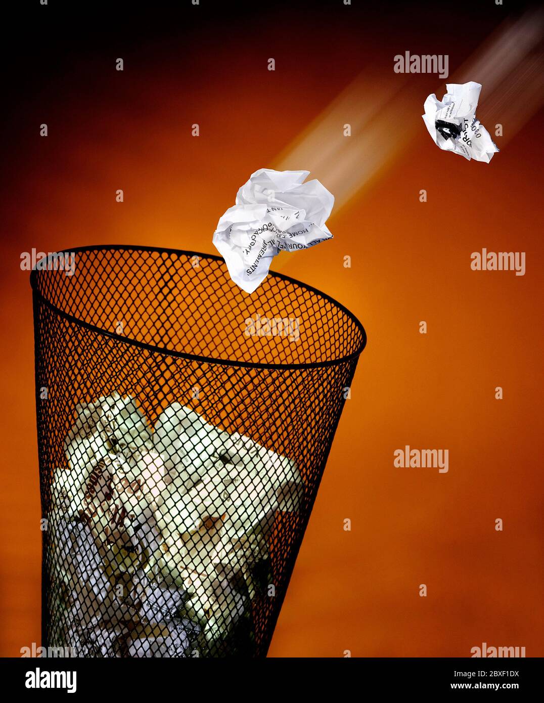 Throwing waste paper into a rubbish bin Stock Photo - Alamy