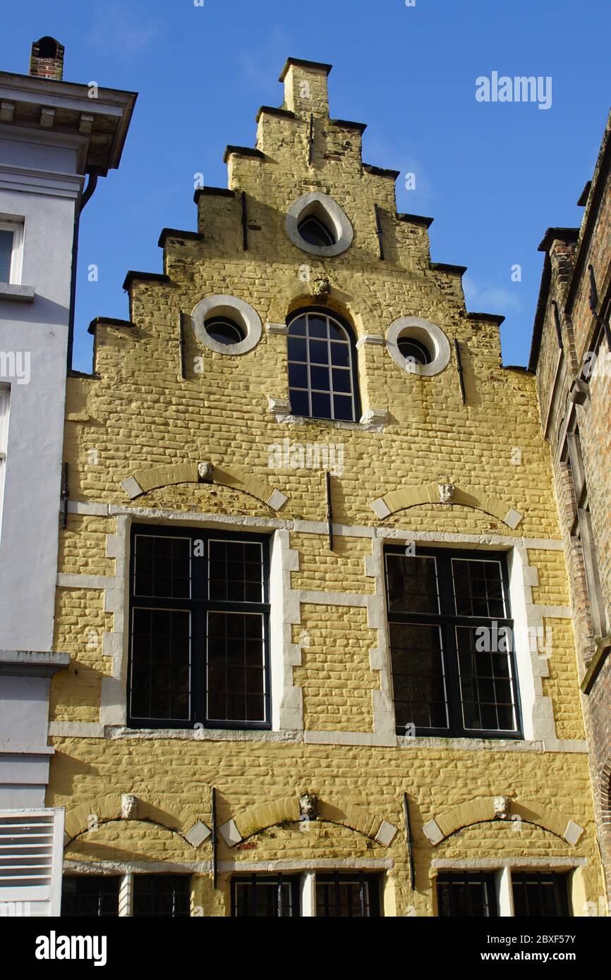 Facade of a Yellow House with Step Gable Roof in Bruges’ Old Town Stock ...