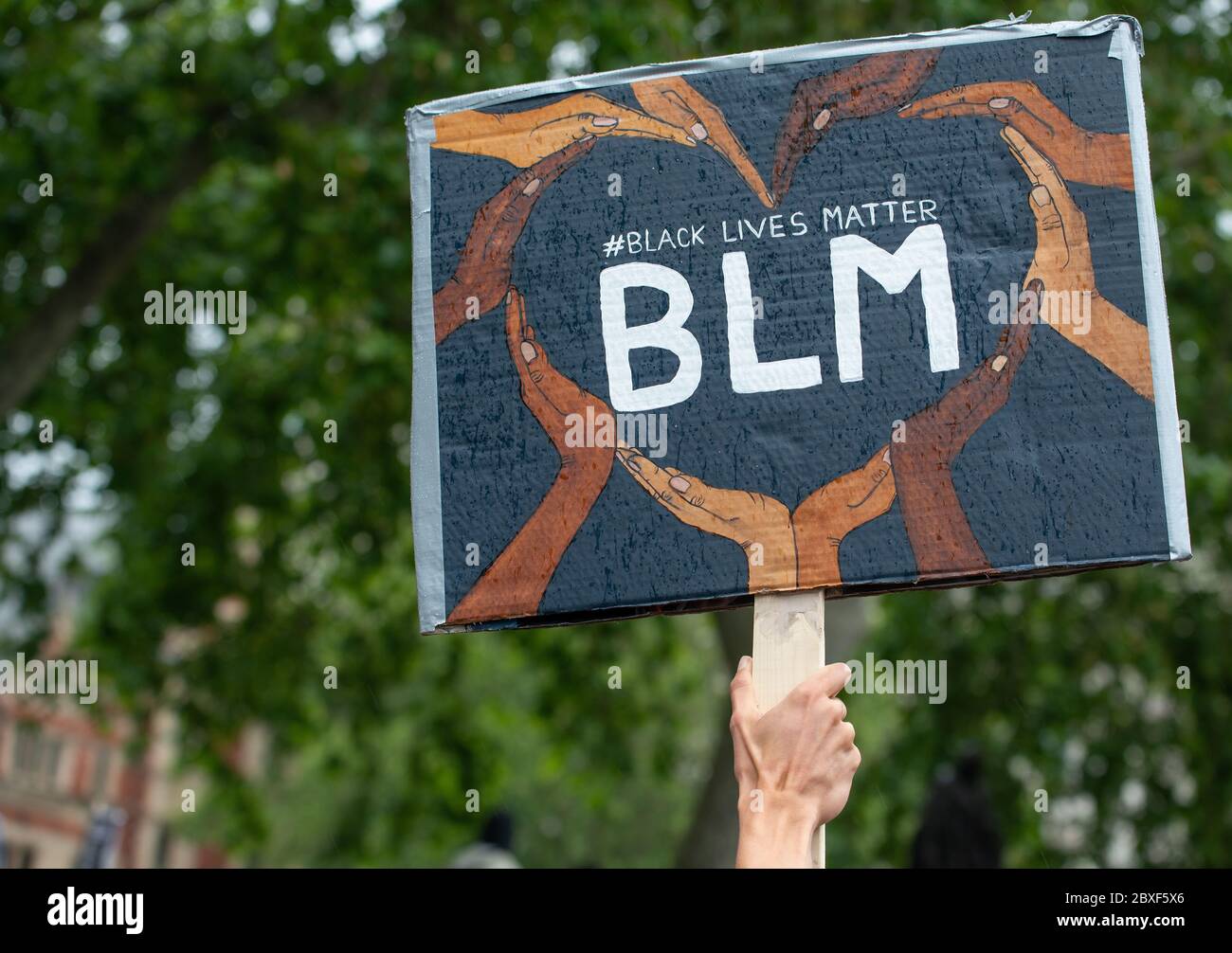 Protester holding up campaign / supportive poster/ sign, at the London ...