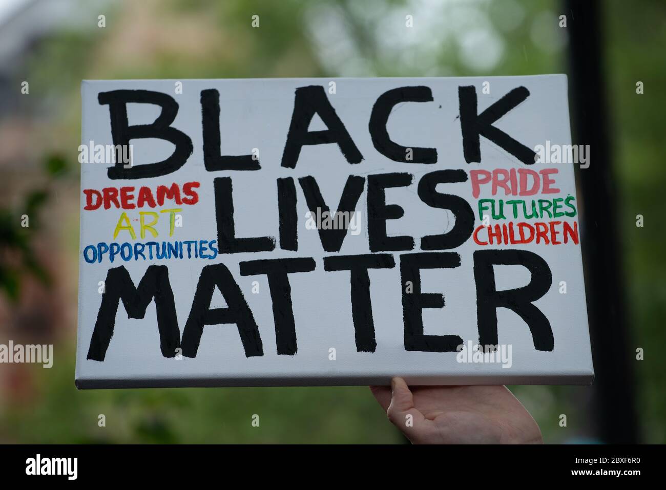 Protester holding up campaign / supportive poster/ sign, at the London ...