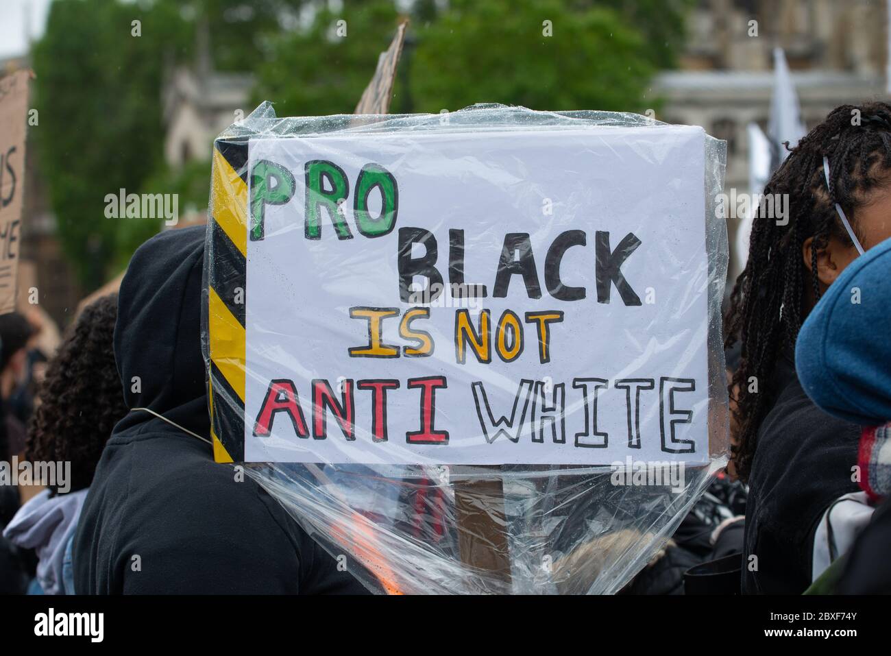Protester holding up campaign / supportive poster/ sign, at the London ...
