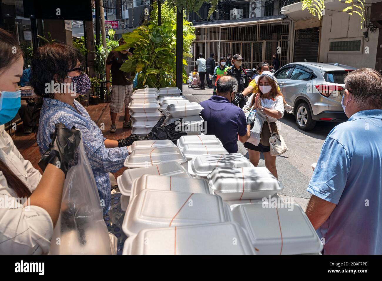 Volunteers giving out free food to poor people at food kitchen during ...