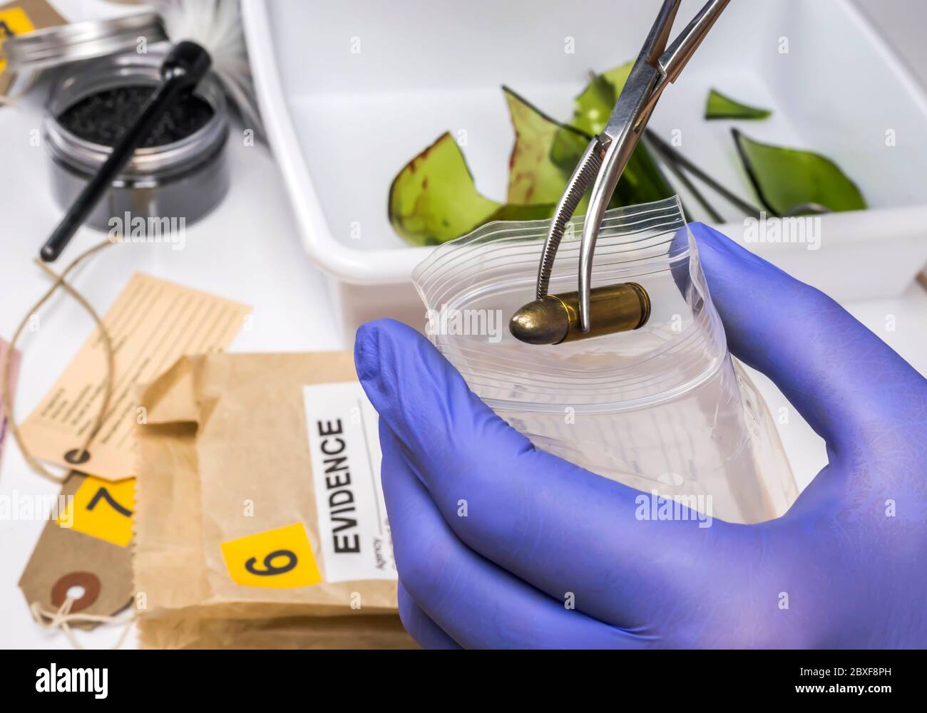Scientific police examining a bullet cap in ballistic Laboratory ...