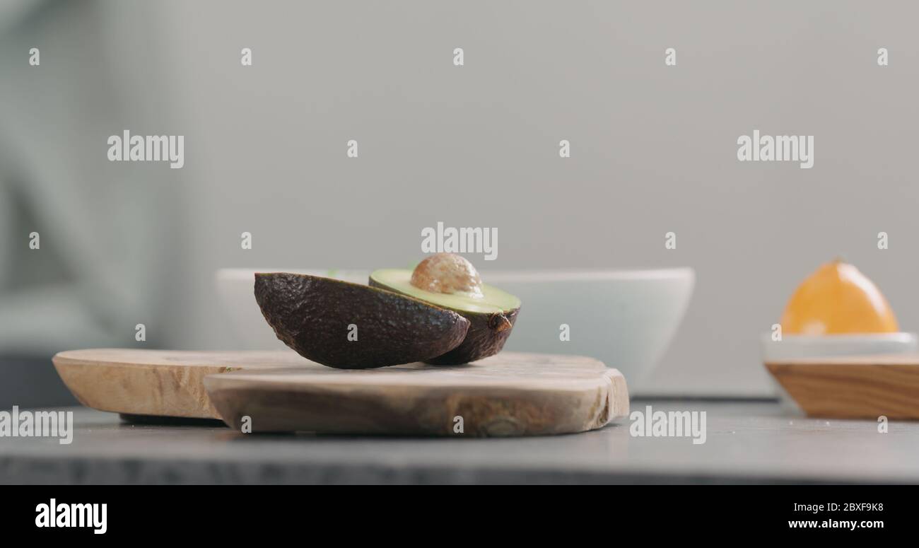 open ripe avocado on kitchen countertop side view Stock Photo - Alamy