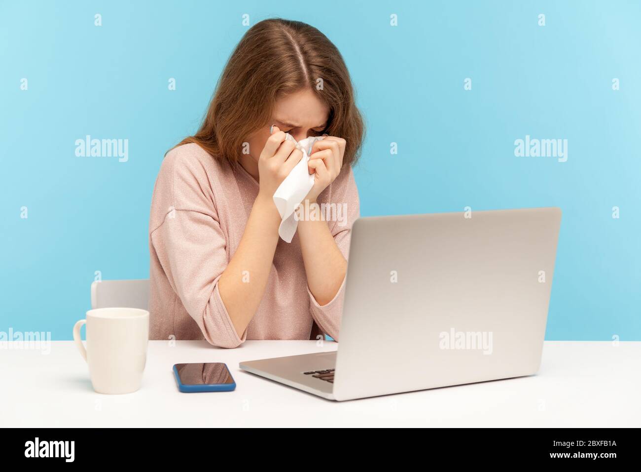 Depressed overworked female employee crying and wiping tears with ...