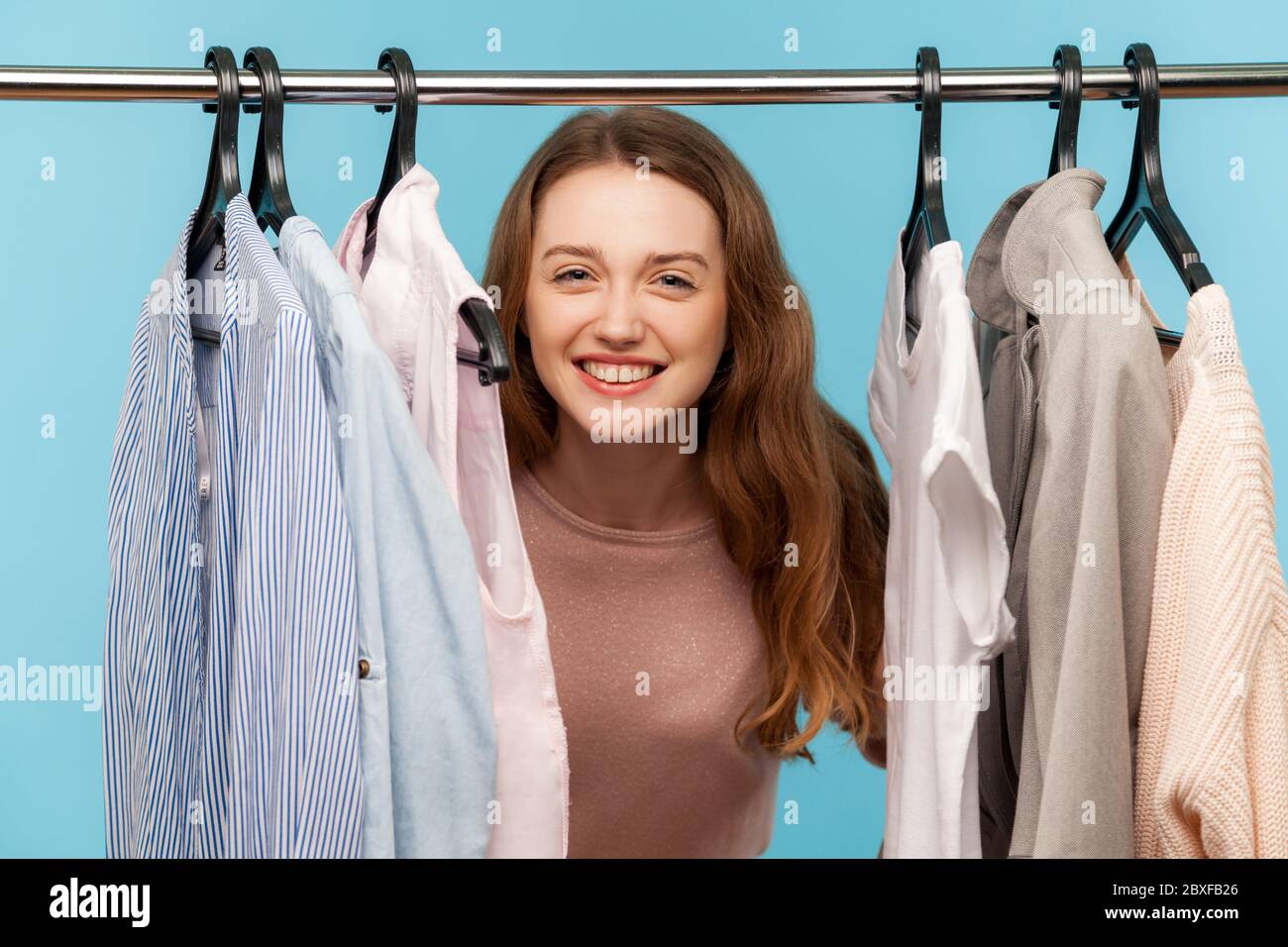 Woman playfully hanging clothes hi-res stock photography and images - Alamy