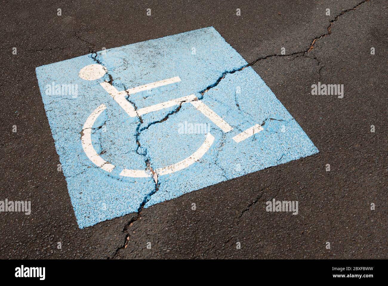 Handicap parking bay with eroded asphalt surface Stock Photo - Alamy