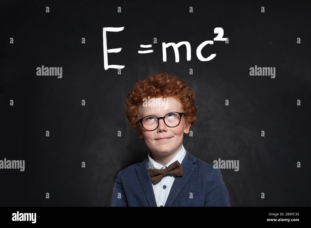 Redhead child student looking at science formula Stock Photo - Alamy
