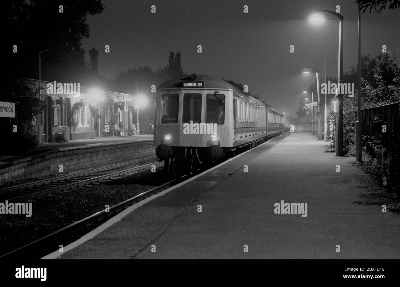 A diesel multiple unit train at Warwick station at night, Warwickshire ...