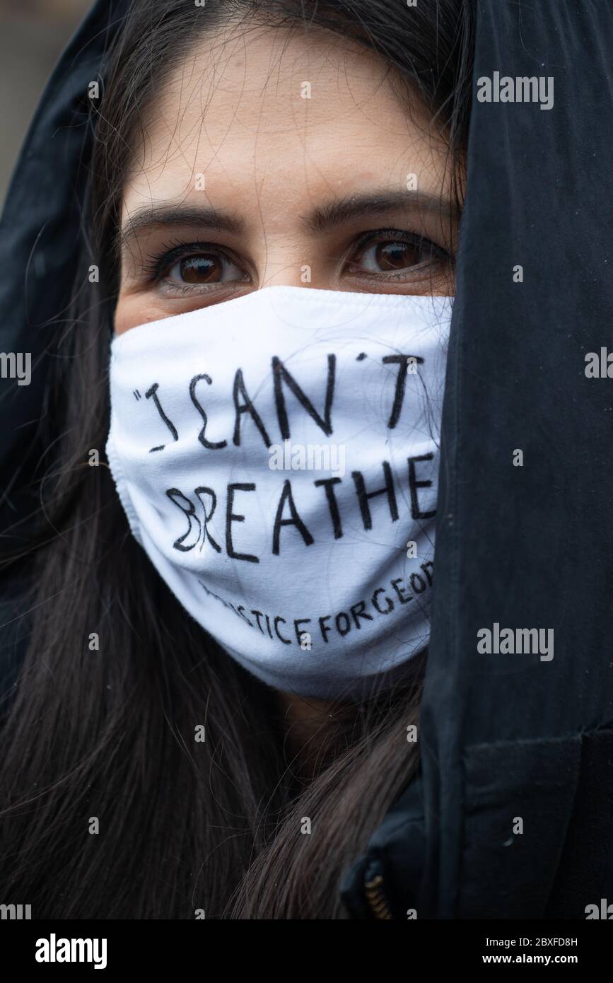 Female protester with I CAN'T BREATHE written on her face mask, at the ...