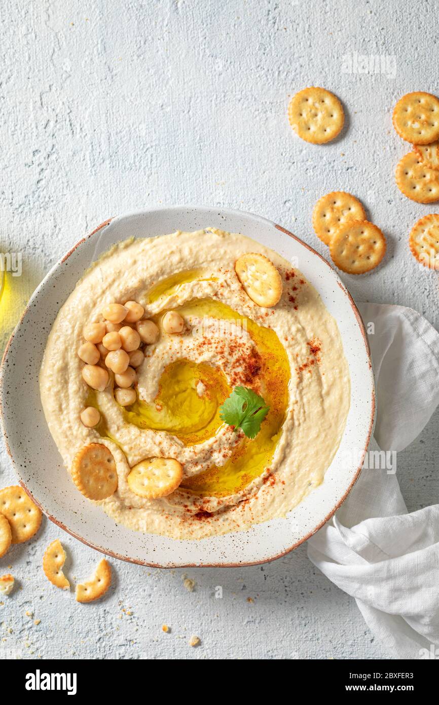 Yummy hummus with crackersi, coriander and lime Stock Photo - Alamy
